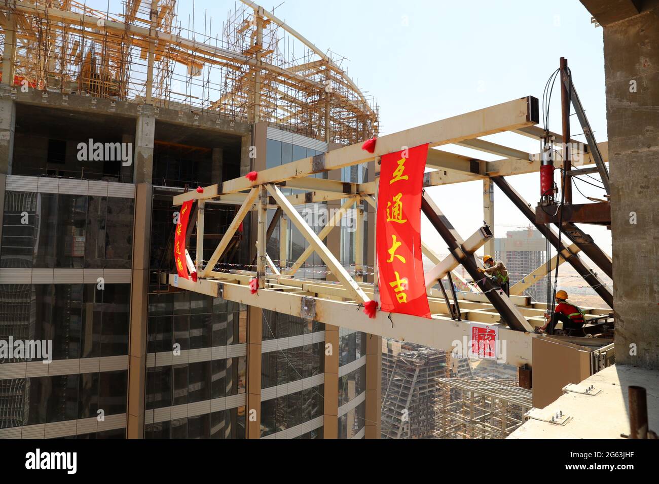 Cairo. 30th June, 2021. Workers install a steel skyway linking two ...