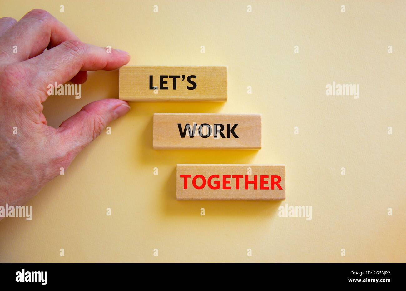 Work together symbol. Wooden blocks with words Let is work together on ...