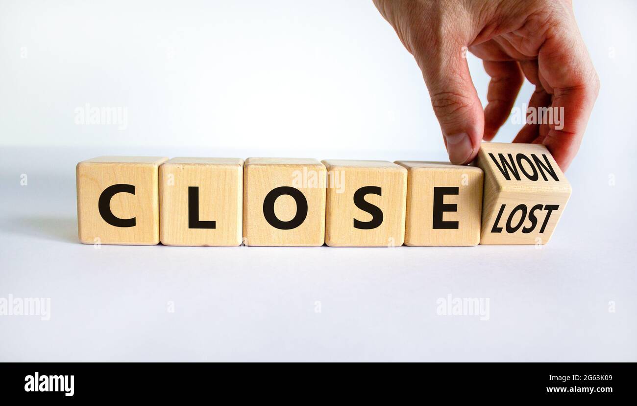 Close won or lost symbol. Businessman turns the wooden cube and changes ...