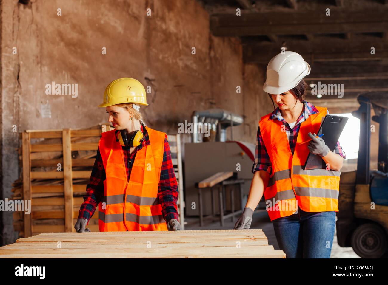 The young women in uniform working in a factory Stock Photo - Alamy