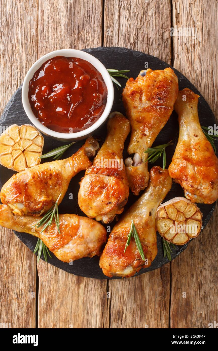 Grilled chicken legs with garlic and rosemary served with barbecue ...