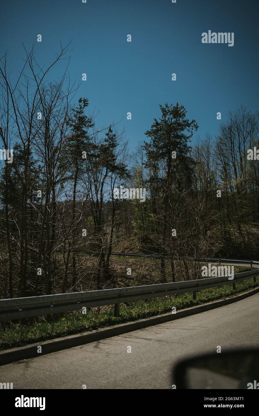 Vertical shot of an empty highway road along safety steel barrier view ...