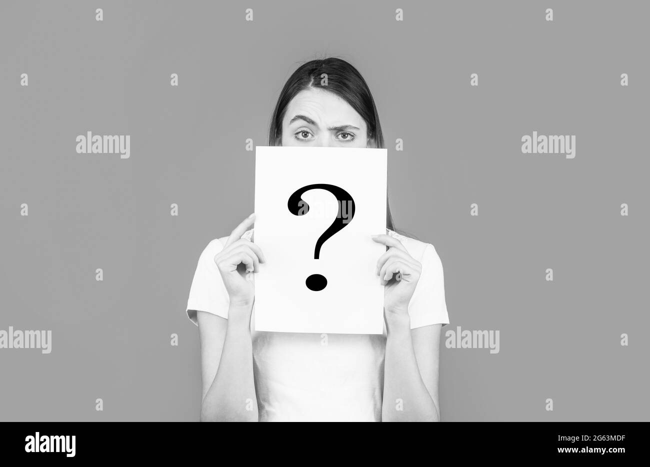 Girl holding sign question mark Black and White Stock Photos & Images ...