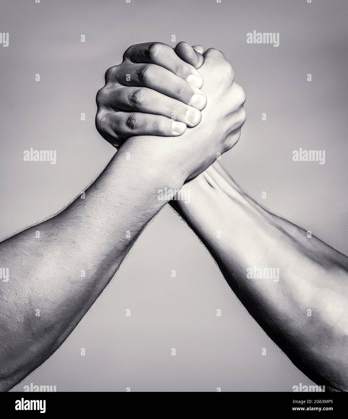 Two men arm wrestling. Arms wrestling. Closep up. Friendly handshake ...