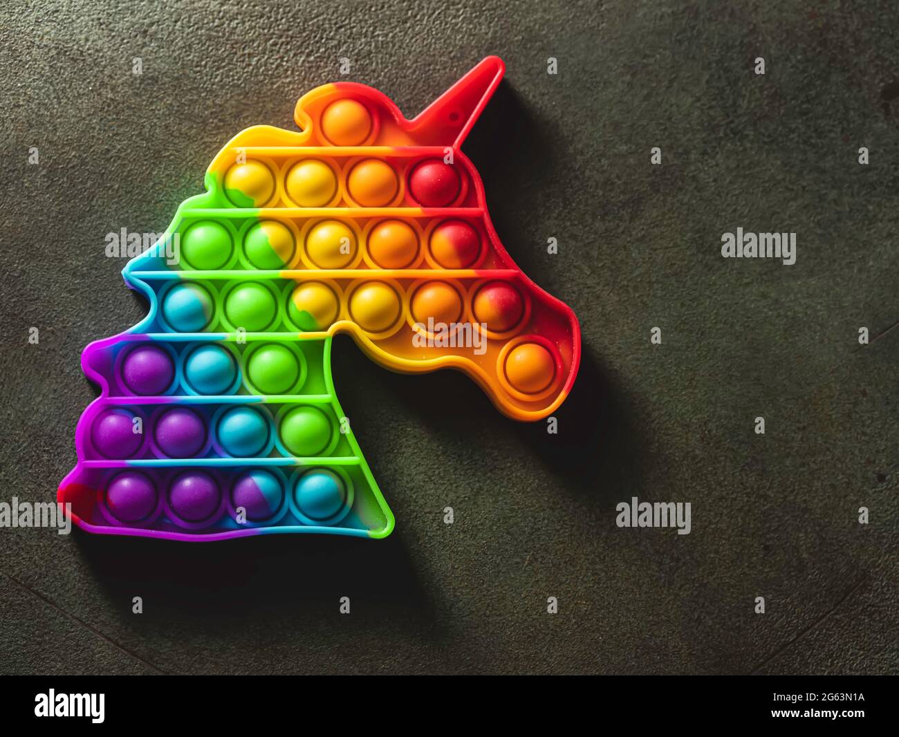 Pop it toy, rainbow colors, in the form of a unicorn. Multi-colored ...