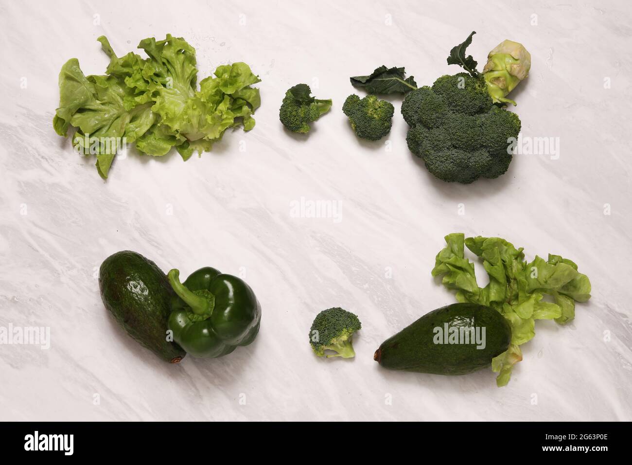 Green vegetables lay on a top of white marble Stock Photo - Alamy