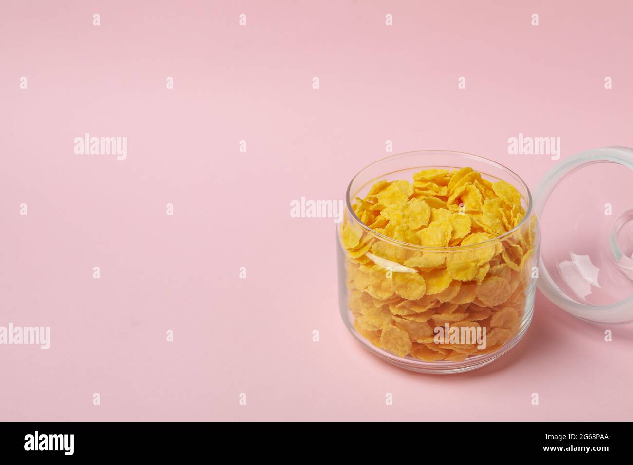 Jar of corn flakes on pink background Stock Photo - Alamy