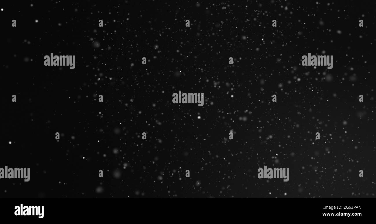 Defocussed white particles floating on a black background Stock Photo ...