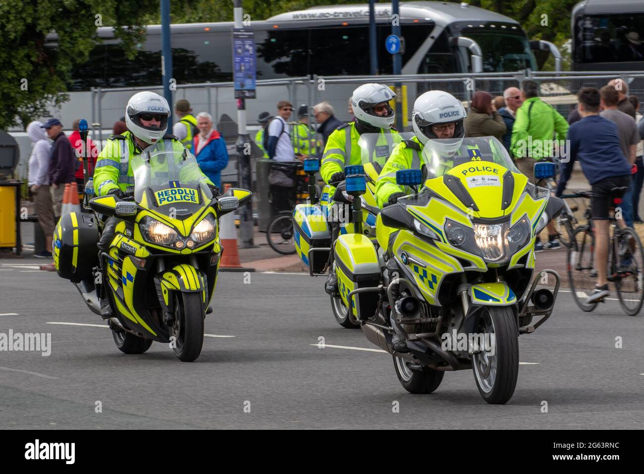 Three Police officers on motorcycles at the front or a motorcycle ...