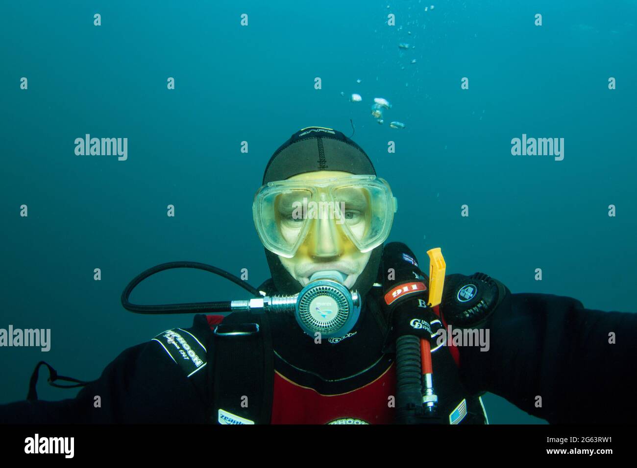 Scuba diver floats mid water taking a self portarit in Plymouth Sound ...