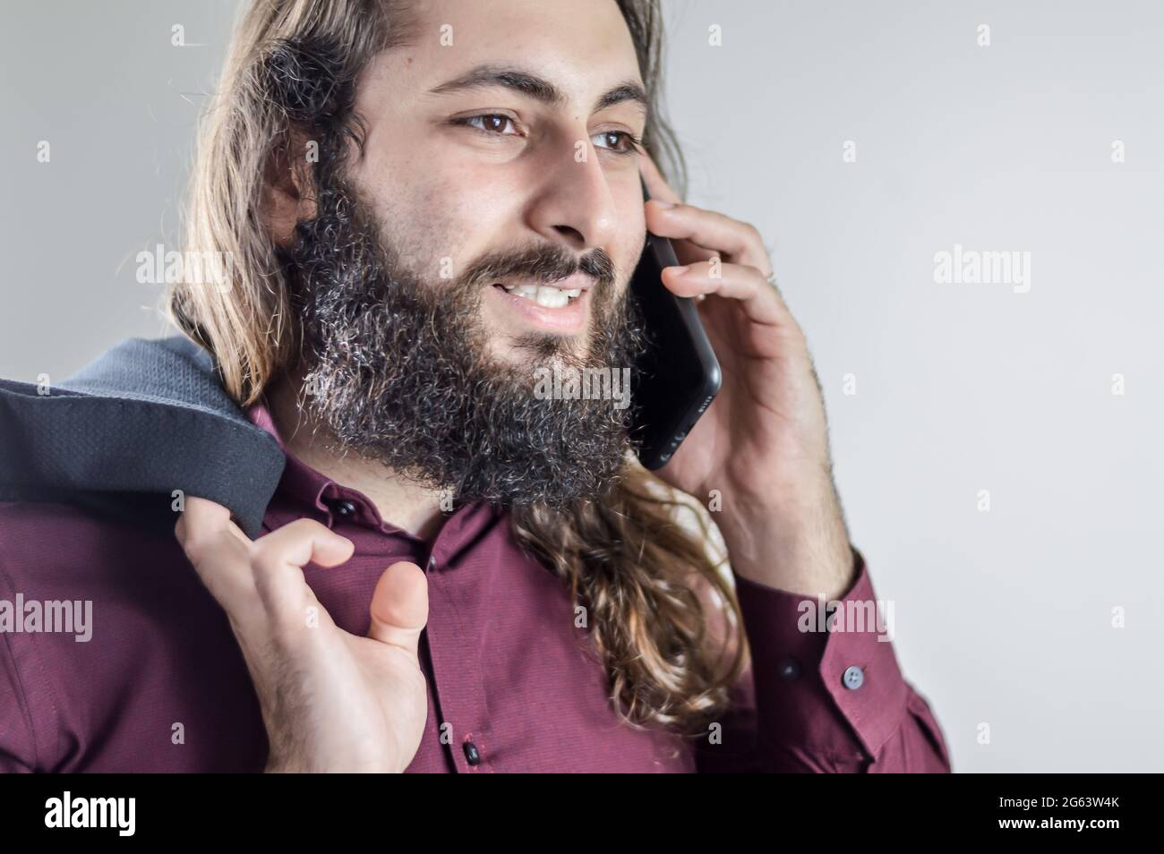 portrait of a young middle eastern businessman with beard and long hair ...