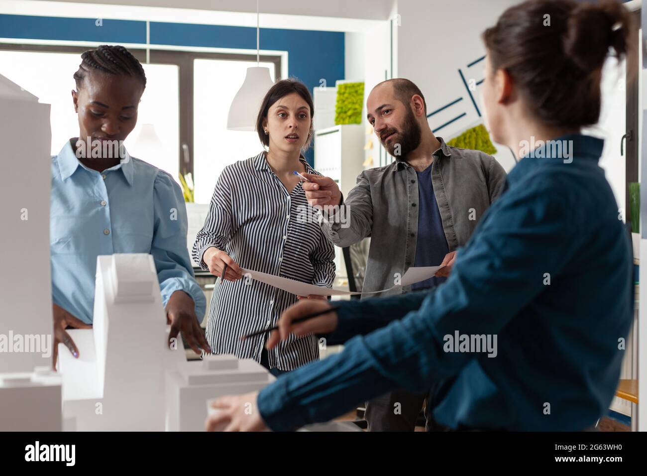 Architectural diverse work group talking about project design ...