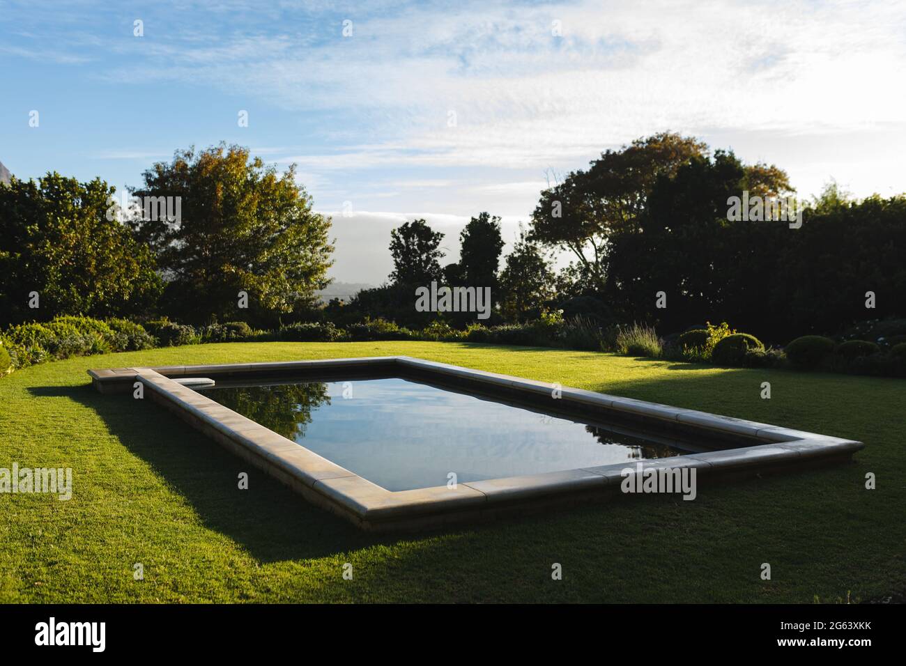 General view of tranquil swimming pool in stunning sunny countryside ...