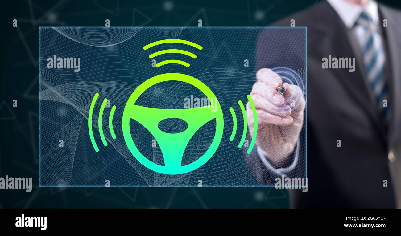 Man touching a self-driving car concept on a touch screen with a stylus ...