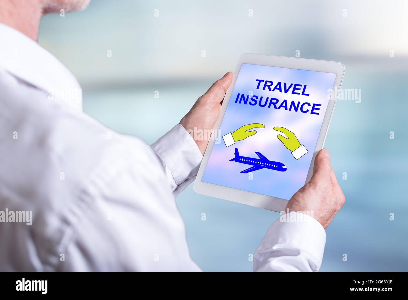 Tablet screen displaying a travel insurance concept Stock Photo - Alamy