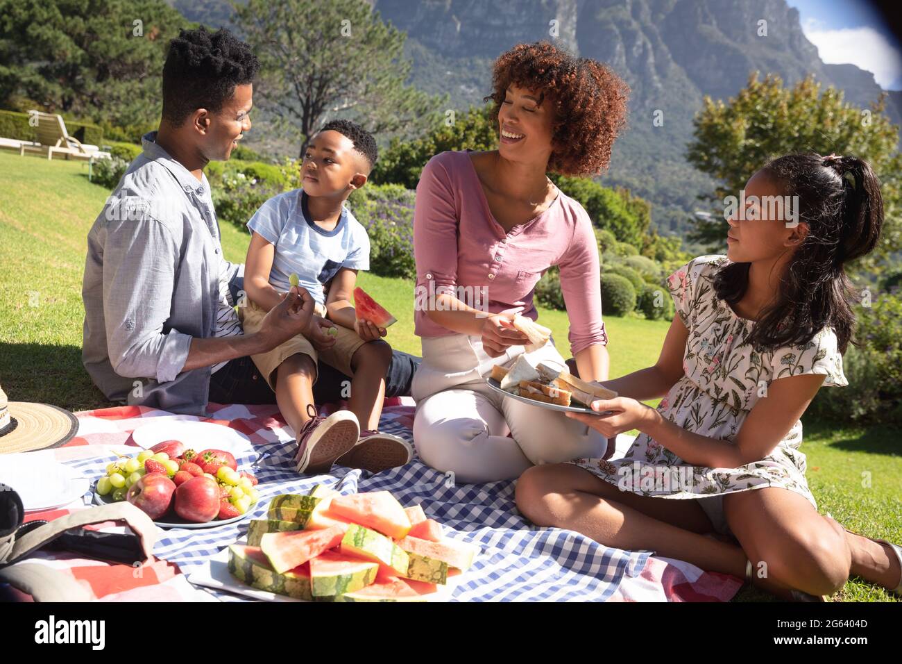 Happy african american couple with son and daughter outdoors, having ...