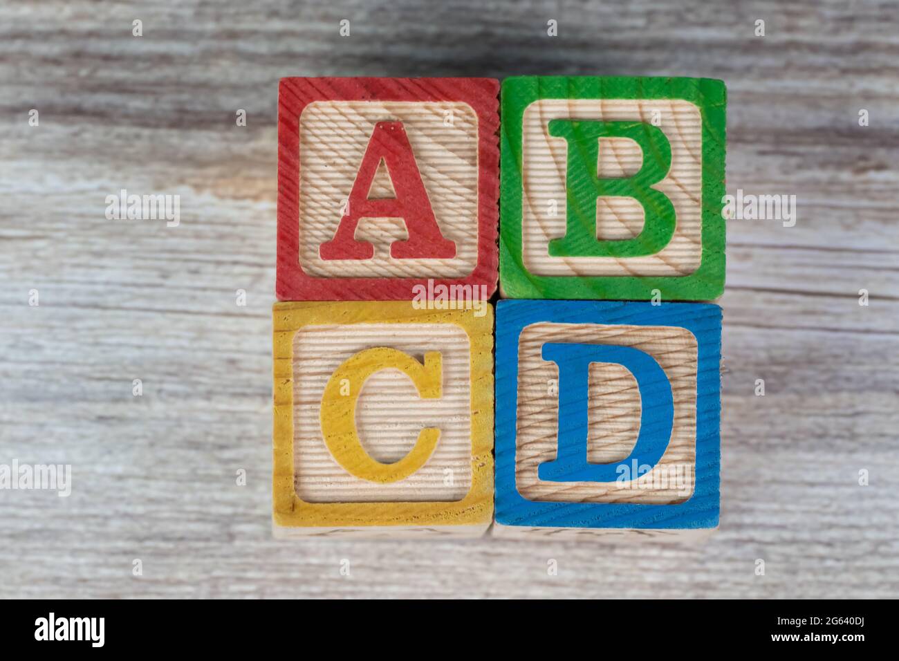 ABCD wooden block alphabet puzzle on wood background Stock Photo - Alamy