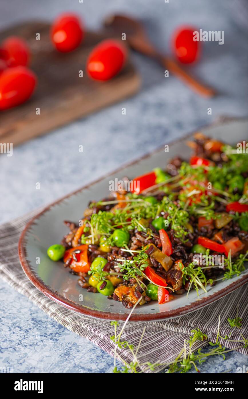 Delicious and organic black rice salad with microgreens Stock Photo - Alamy
