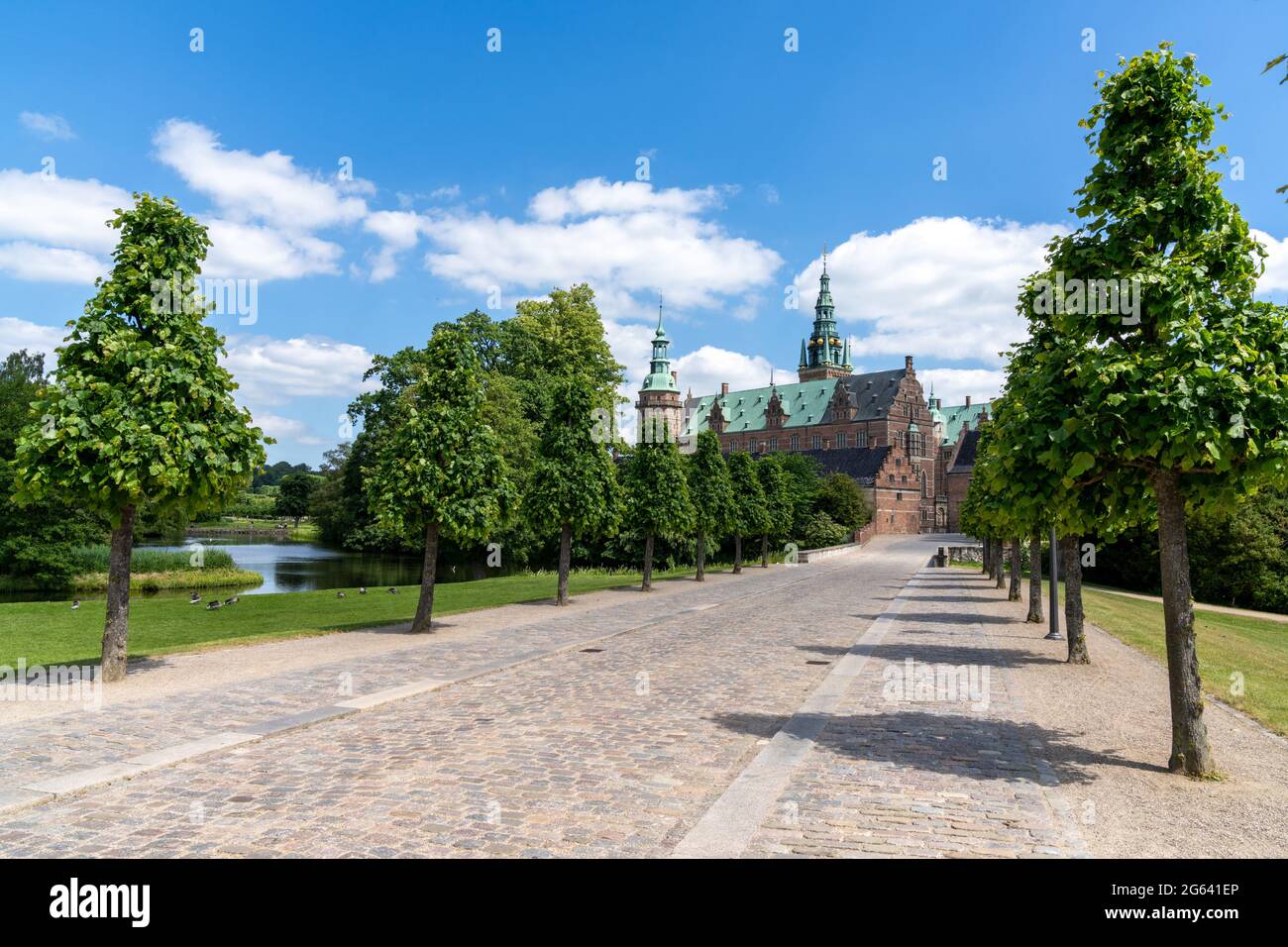 Hillerod, Denmark - 16 June, 2021: long tree-lined alley leading to the ...