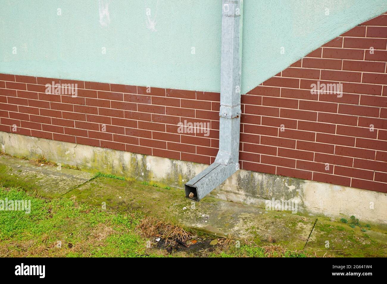 Rain pipe against a stone wall Stock Photo - Alamy