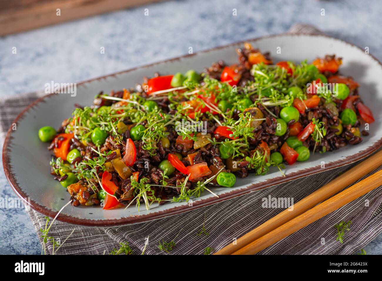 Delicious and organic black rice salad with microgreens Stock Photo - Alamy