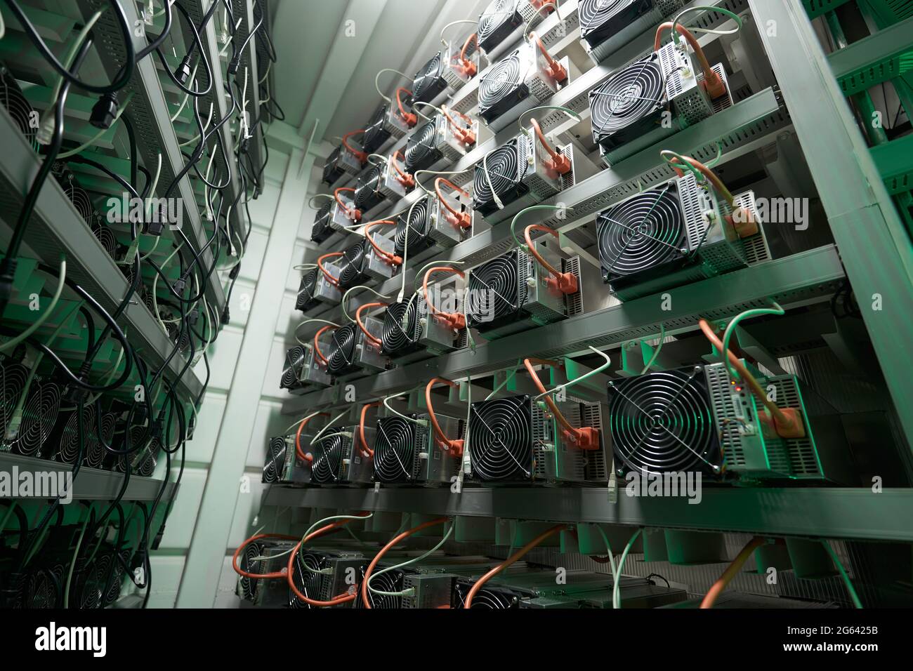 Bitcoin miners in large farm. ASIC mining equipment on stand racks mine ...