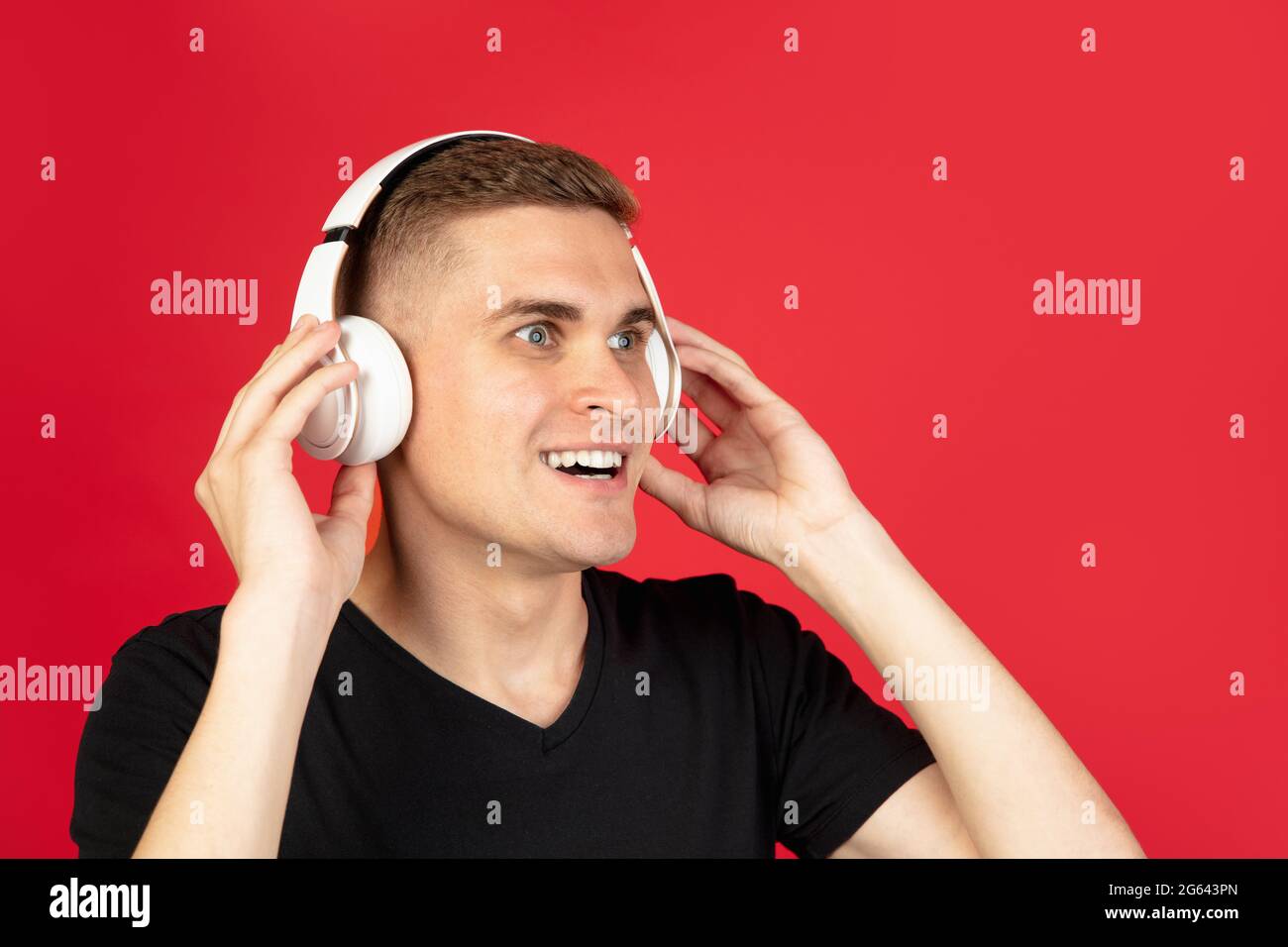 Caucasian man's portrait isolated over red studio background with ...