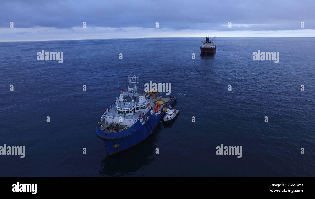 Blue tug boat with white superstructure underway, side view Stock Photo ...