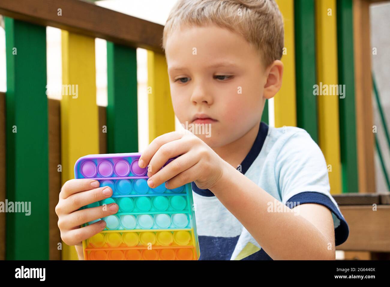Child playing with new silicone toy pop it on the playground.New ...