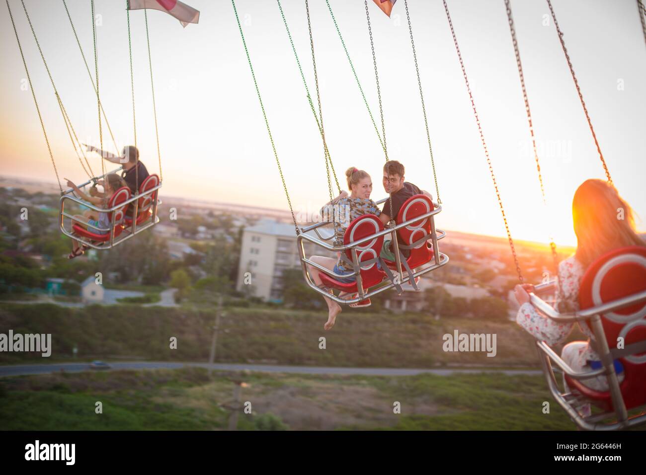 People have fun enjoying the air carousel in the amusement park Stock ...