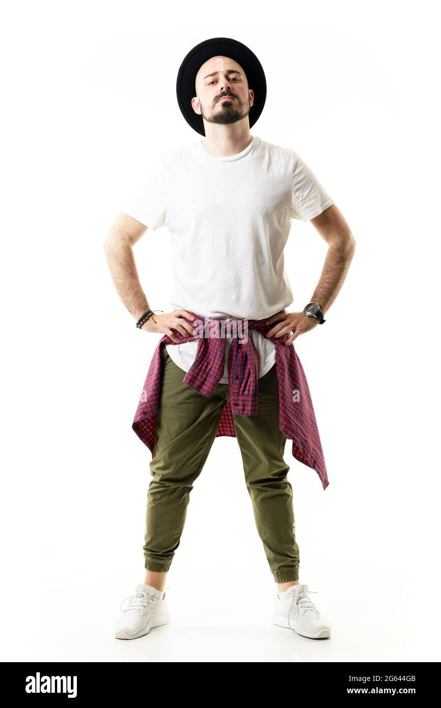 Confident cocky attitude hipster with hat in chino pants posing with ...
