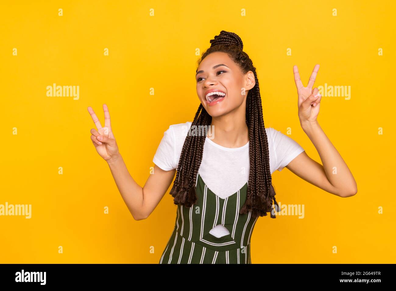 Portrait of attractive cheerful girl showing double v-sign having fun ...