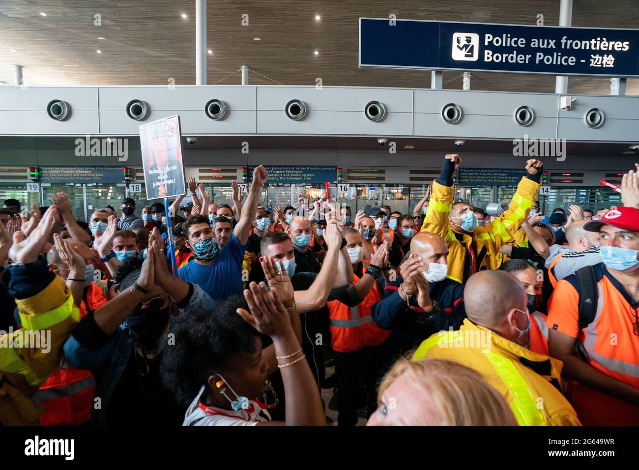 Charles De Gaulle Paris airport workers block terminal to protest for ...