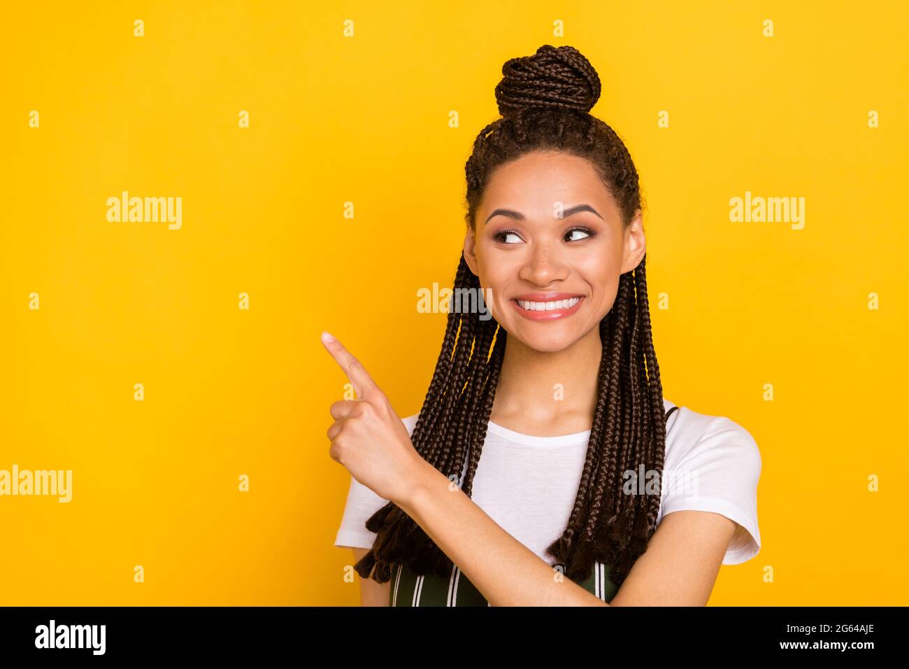 Photo of cheerful young dark skin happy woman look point finger empty ...