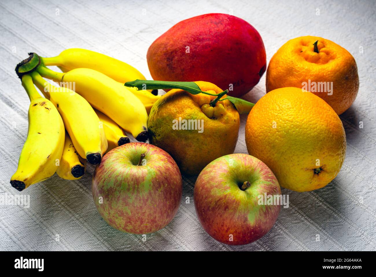 Tropical fruit mix on a table with white tablecloth Stock Photo - Alamy
