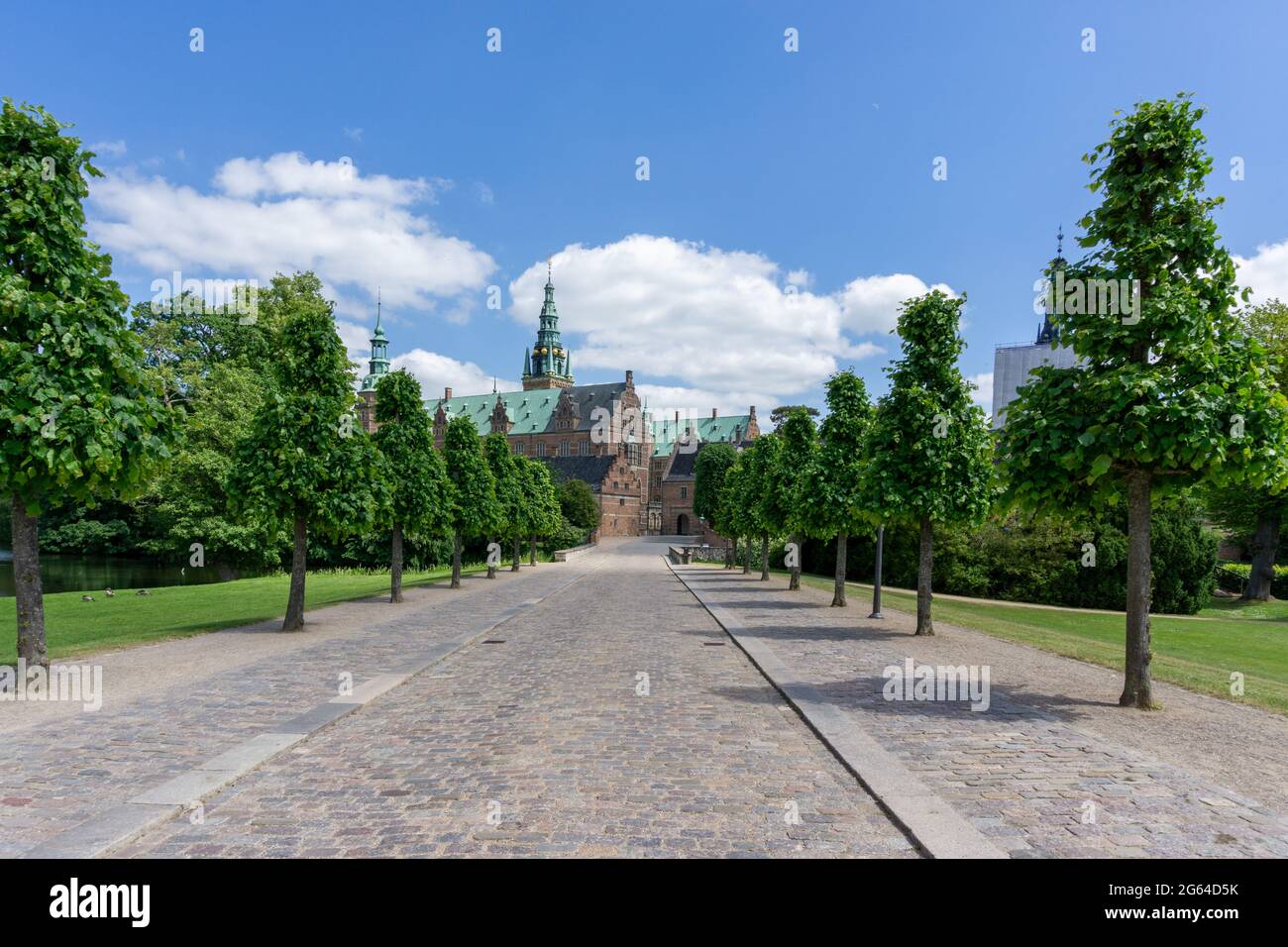 Hillerod, Denmark - 16 June, 2021: long tree-lined alley leading to the ...
