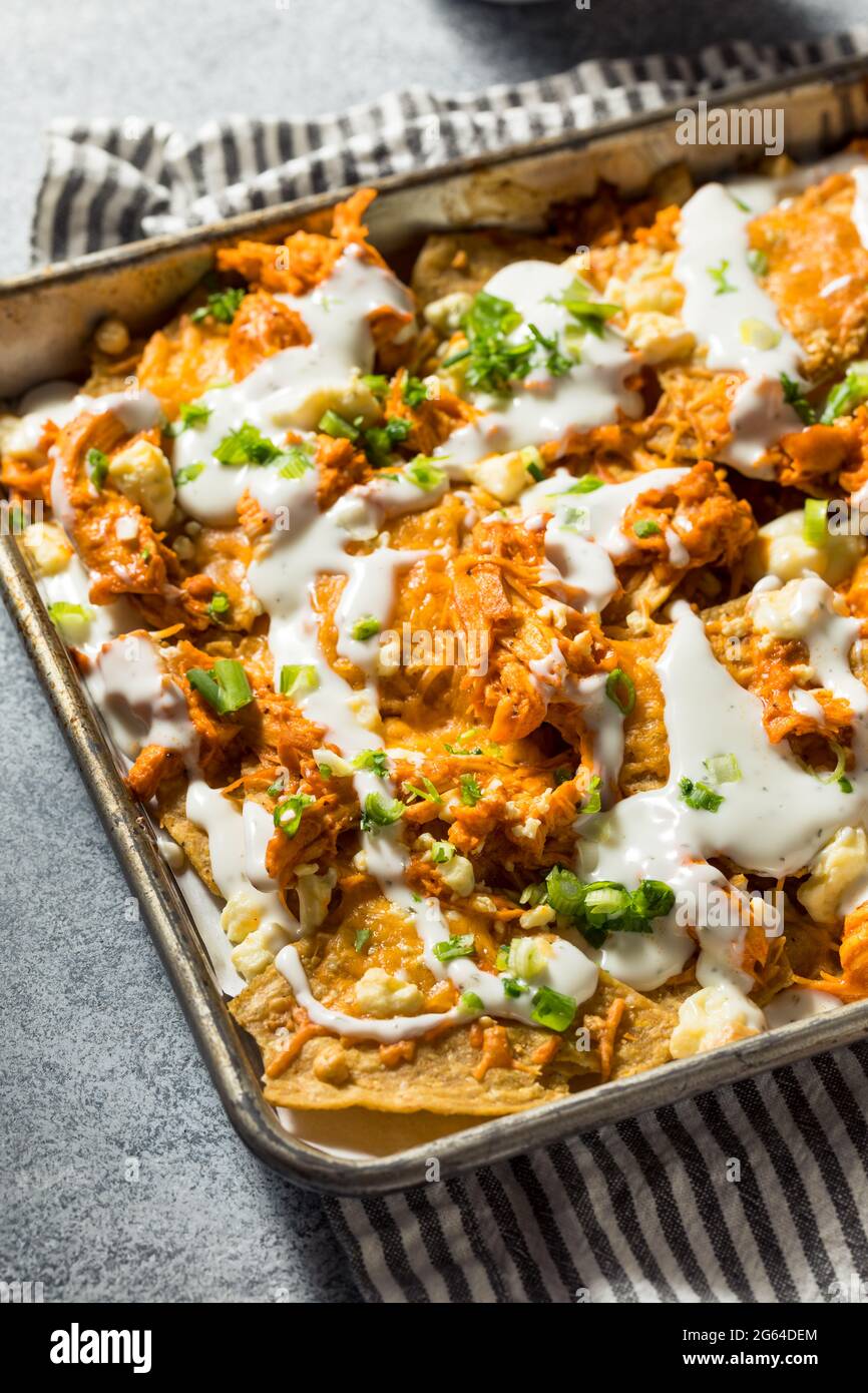 Homemade Buffalo Chicken Nachos with Ranch and Onions Stock Photo - Alamy