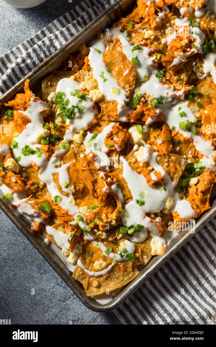 Homemade Buffalo Chicken Nachos with Ranch and Onions Stock Photo - Alamy