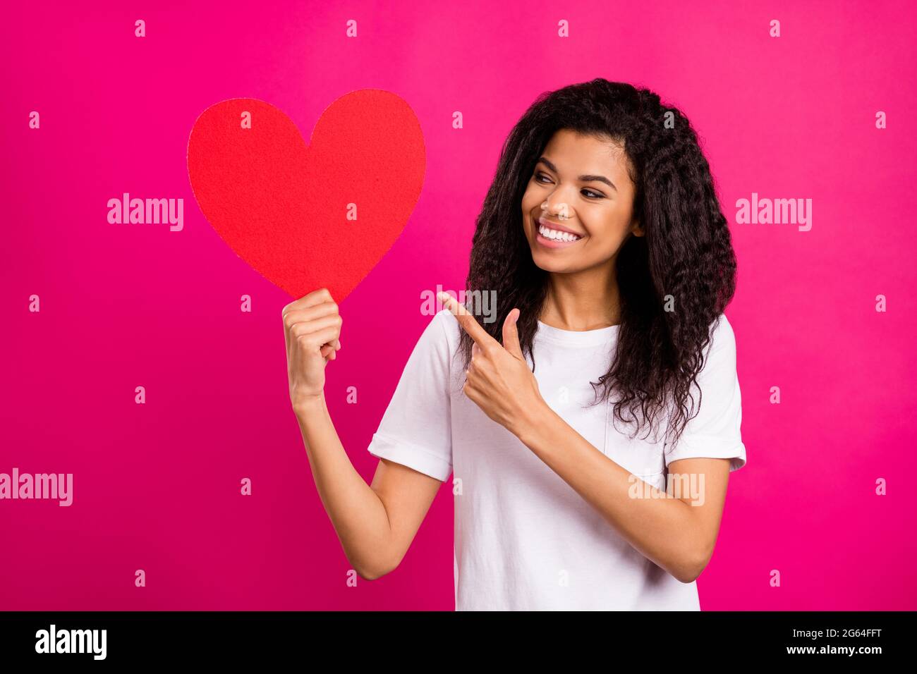 Portrait of attractive trendy cheerful girl demonstrating heart shape ...