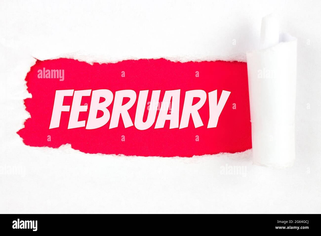 February. Month, Calendar month. Red Hole in the white paper with torn ...