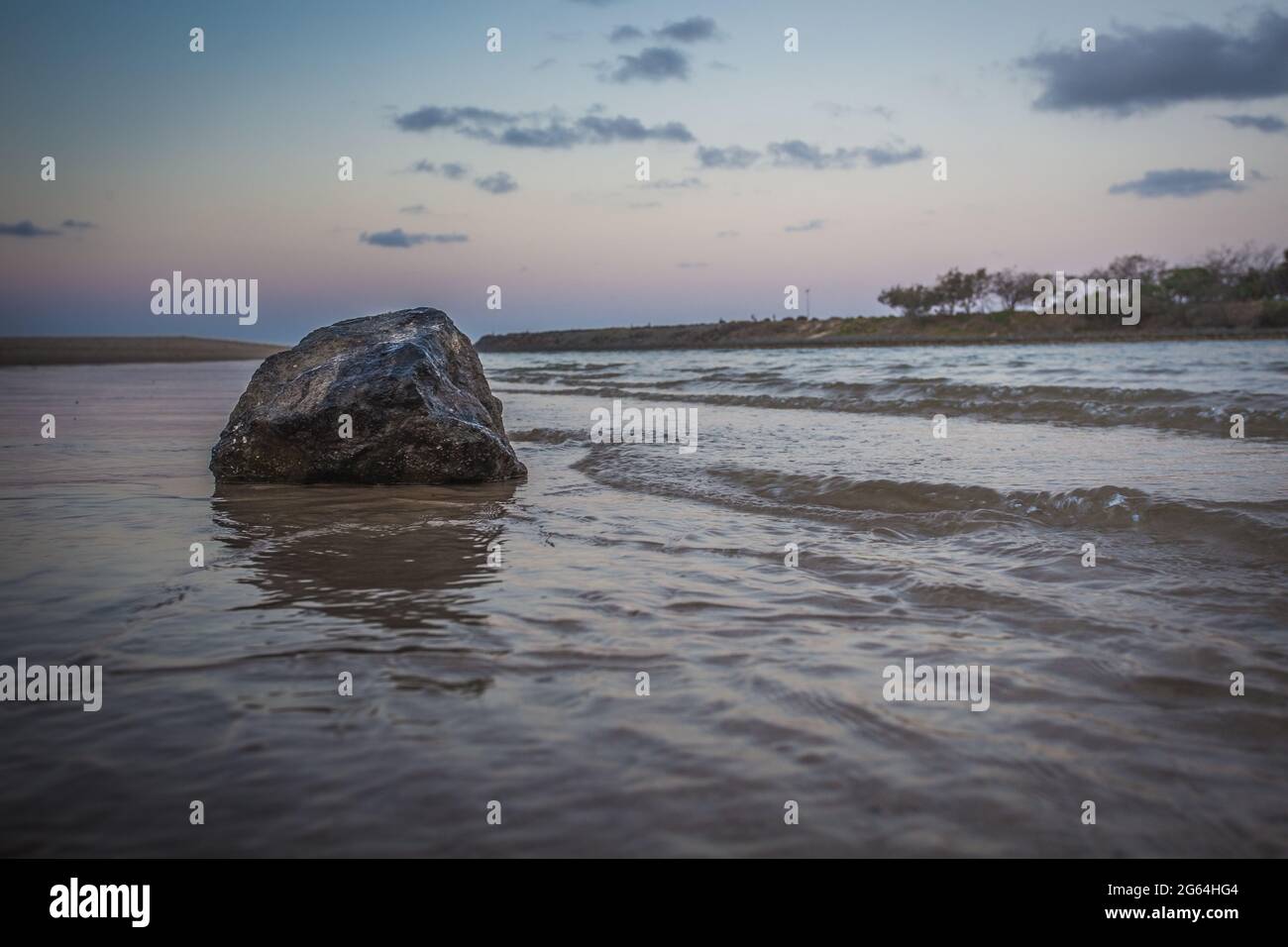 Lone stone standing on a pacific beach in a twilight Stock Photo - Alamy