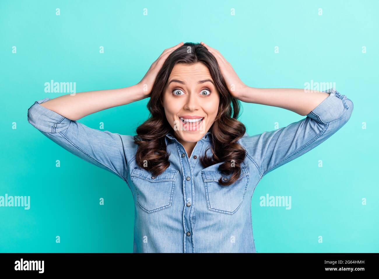 Photo of sweet impressed young lady dressed denim shirt smiling arms ...