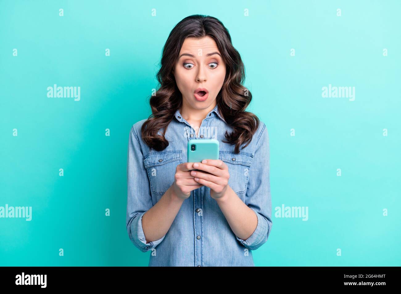 Photo of young girl amazed shocked look read browse fake news cellphone ...