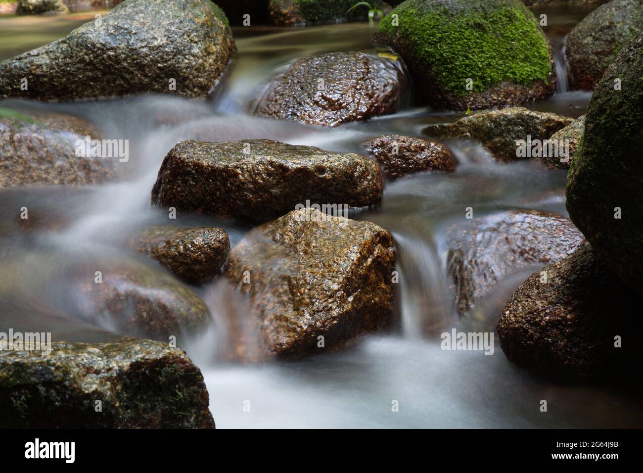 Slow motion timelapse of water running over rocks Port Douglas ...