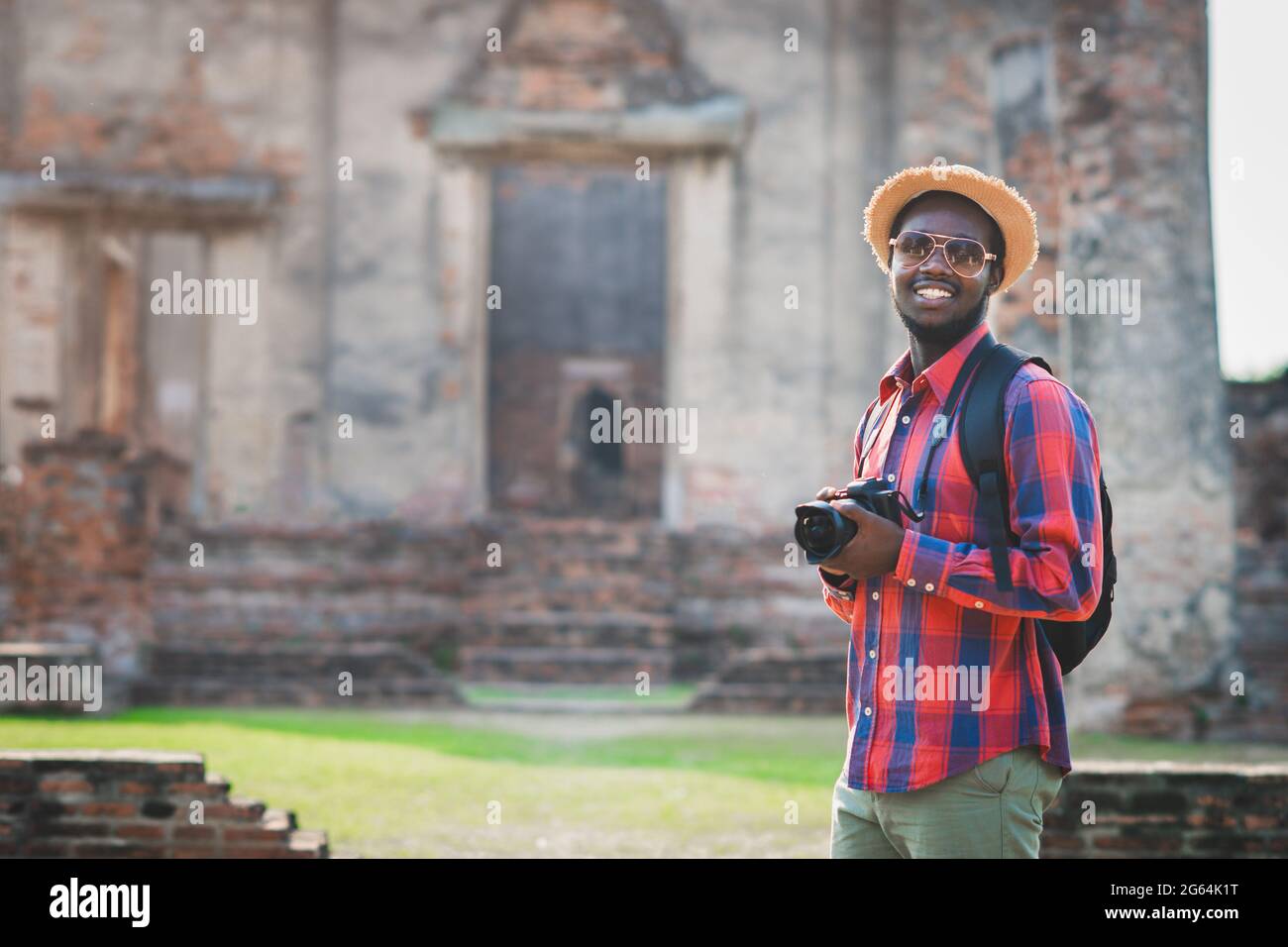 African male photographer enjoying to taking pictures of ancient ...
