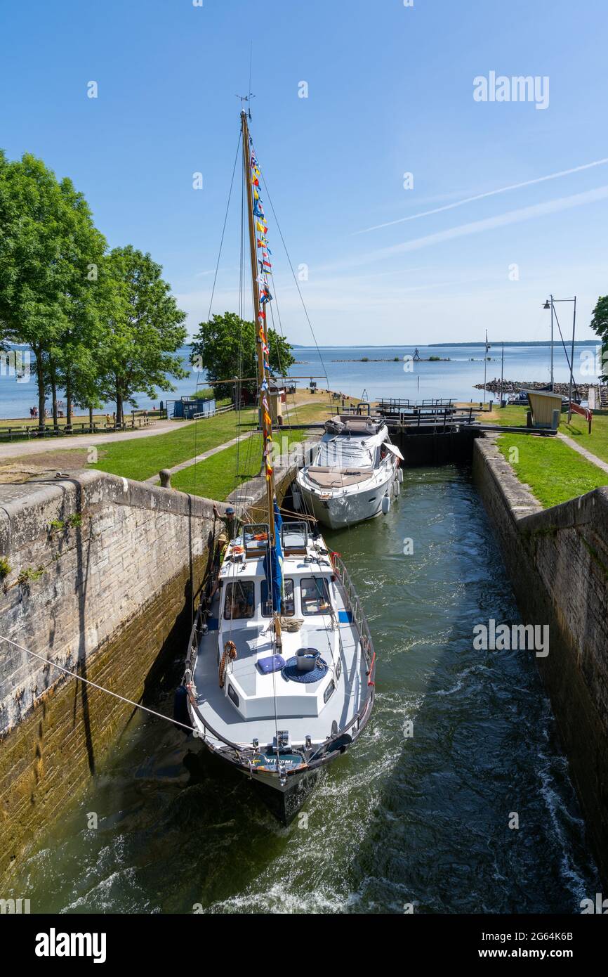 Berg, Sweden - 21 June, 2021: boats travelling upriver in the locks and ...