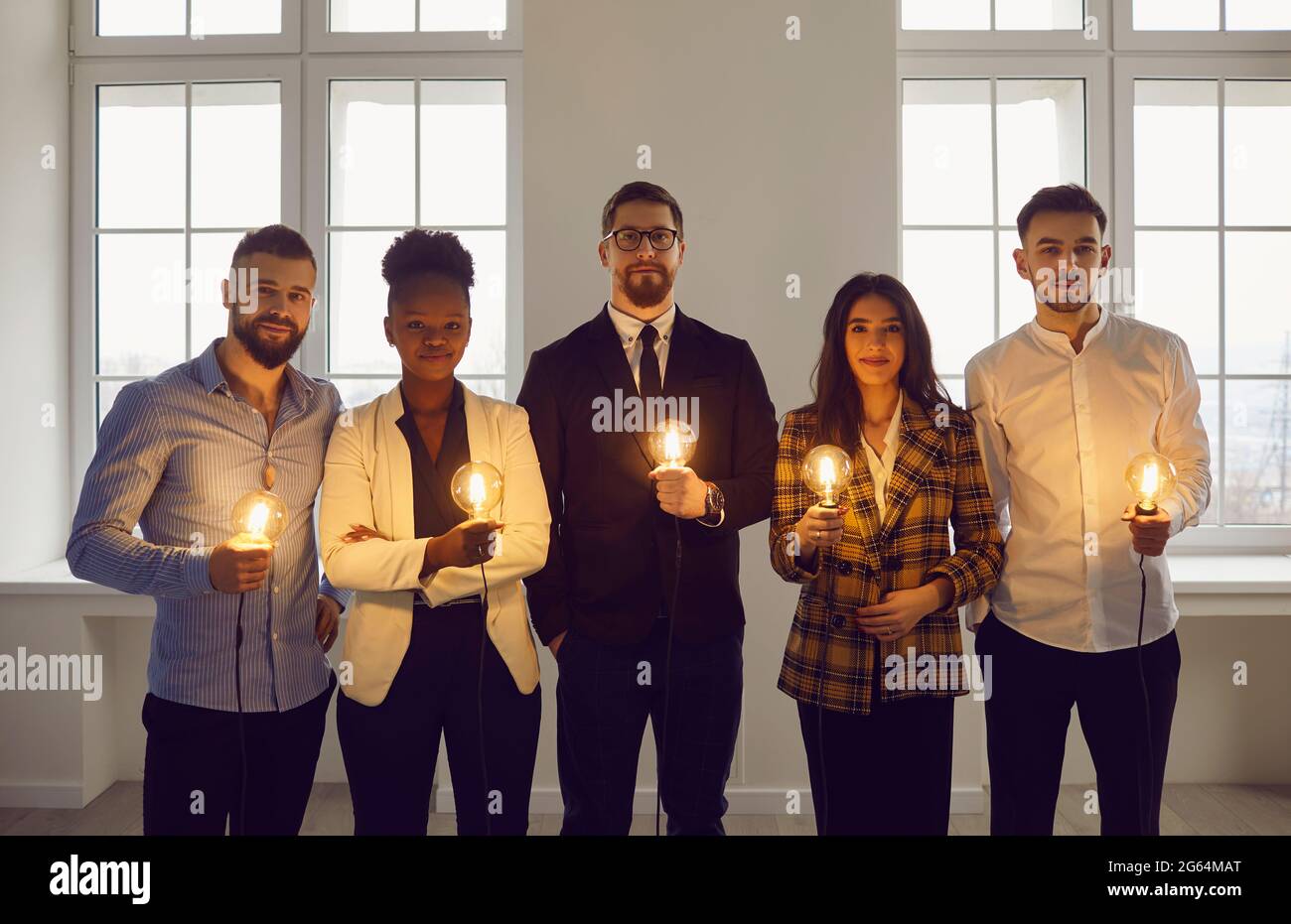 Group of young diverse business people standing in office holding ...