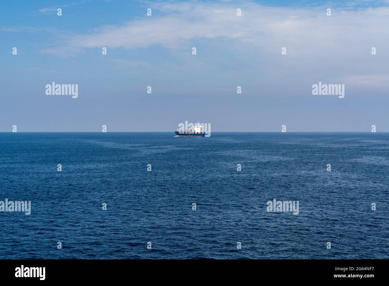 Tars, Denmark - 10 June, 2021: large freight ship travelling full steam ...