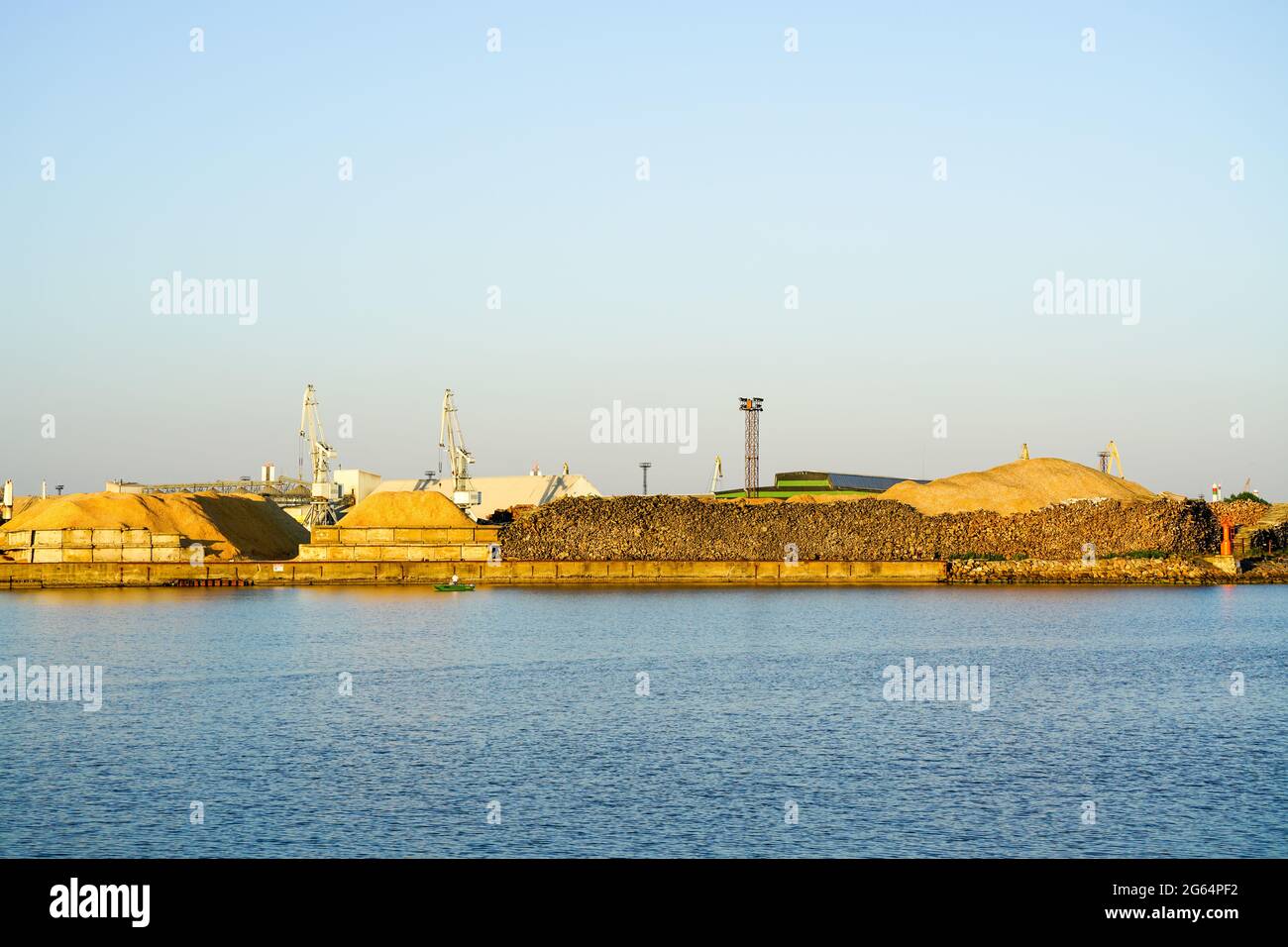 large piles of firewood logs and pyramids of wood chips in harbor Stock ...