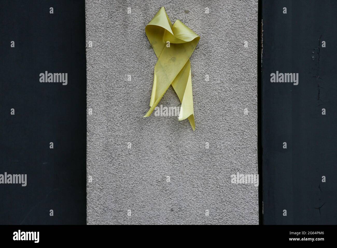 A yellow ribbon is placed outside the house of former Philippine ...